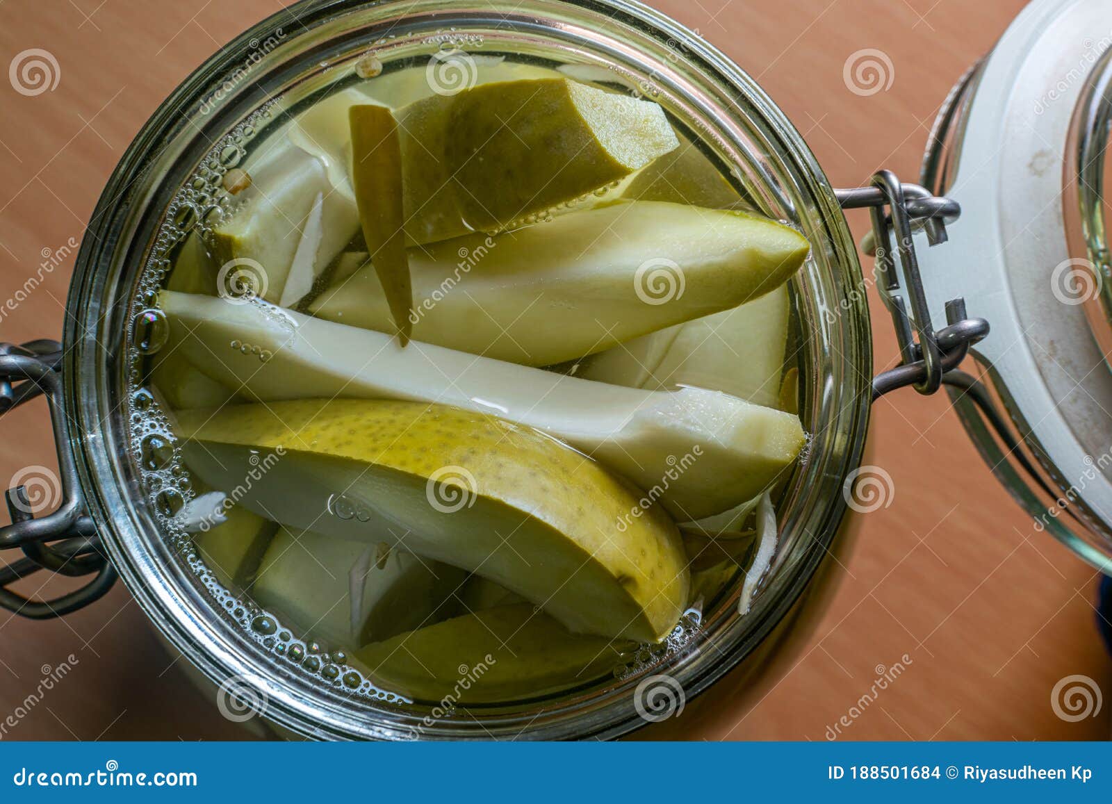 A Bunch of Fresh Salted Mango Pieces in a Glass Jar with Blurry ...