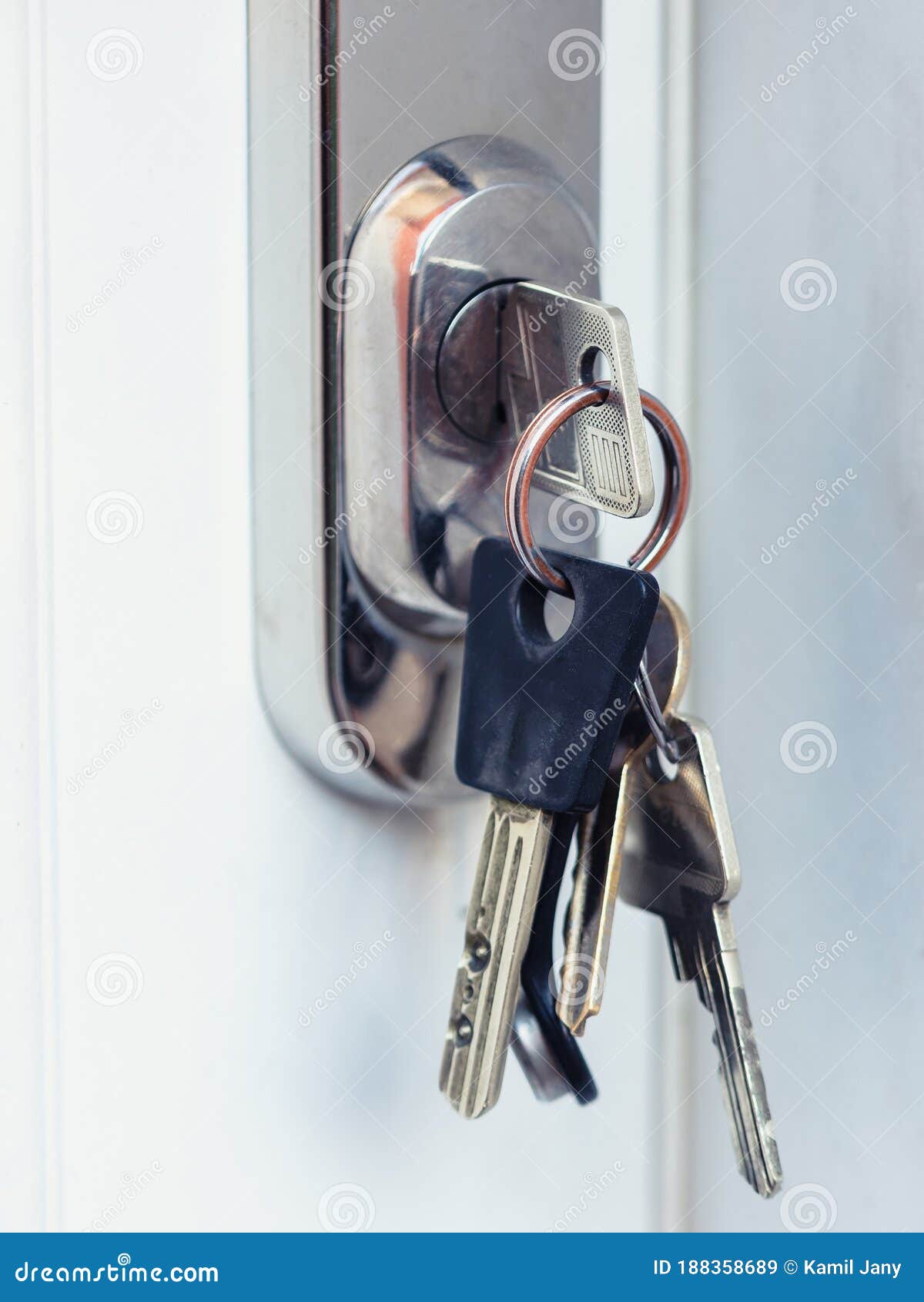 Bunch of Keys Inserted in Door Lock on White Door Stock Image - Image ...