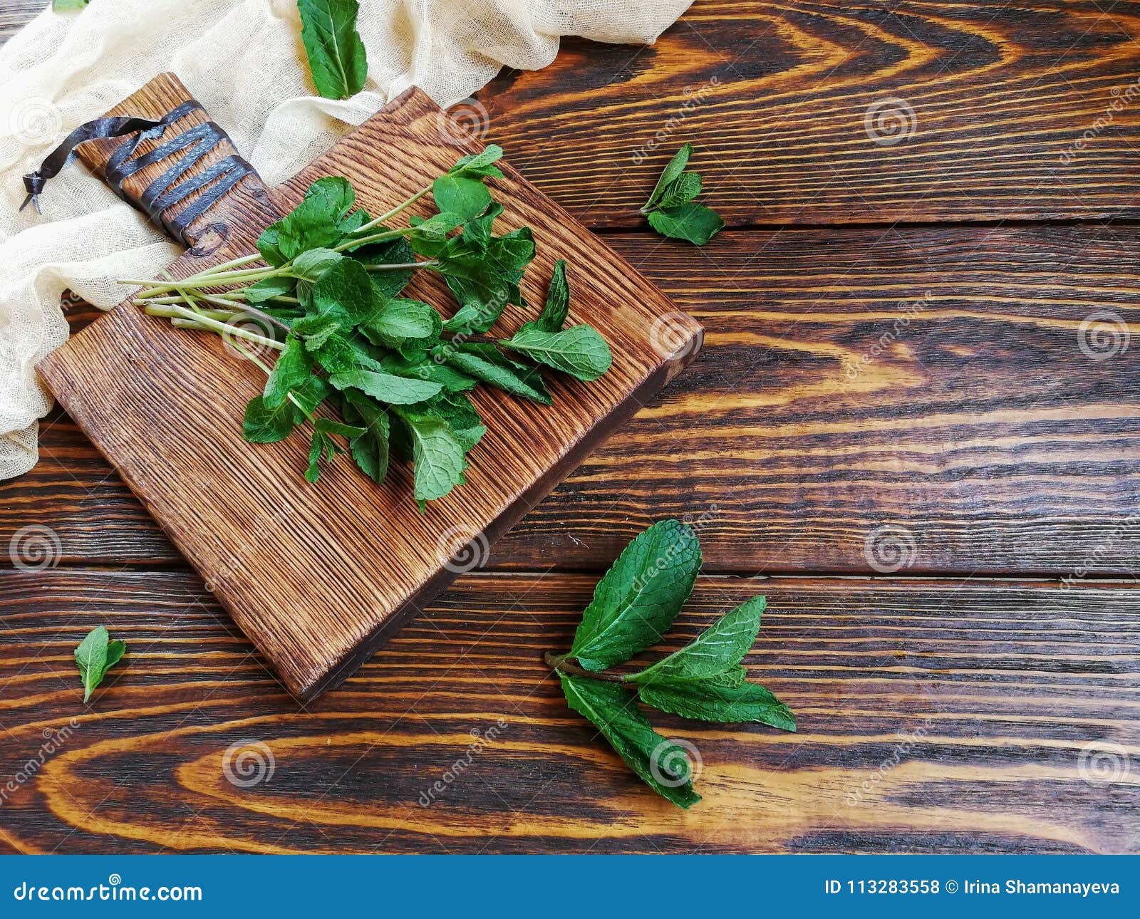 Bunch of Mint on Brown Wooden Chopping Board on Burnt Wooden Background ...