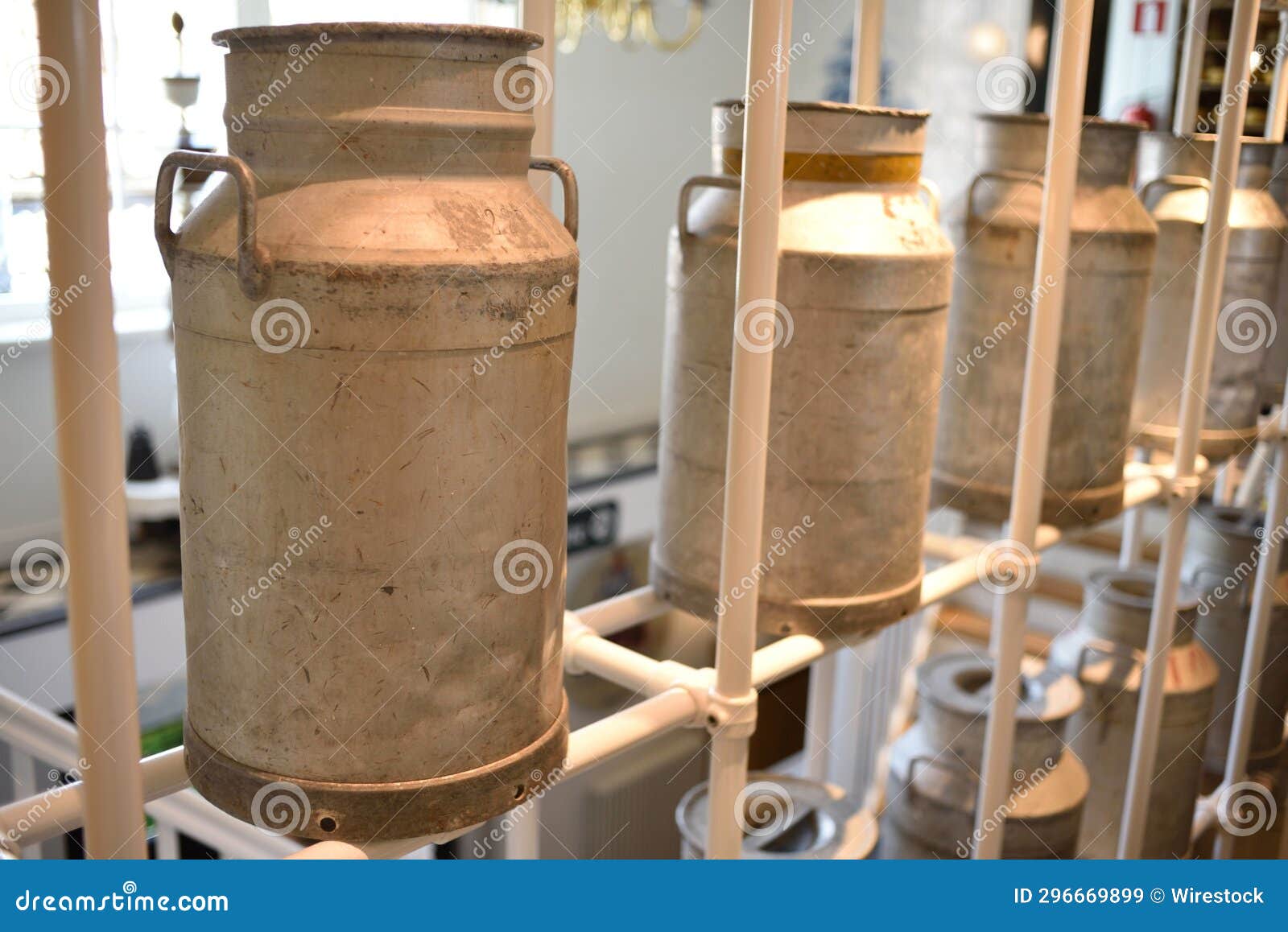 A Bunch of Old Rusty and Battered Milk Cans on Top of Racks Stock Image ...