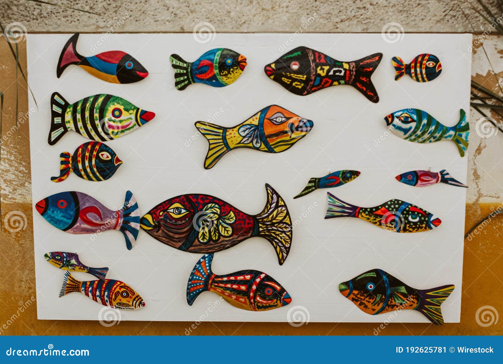 Bunch of Painted Decorative Fish Figurines on a White Tile Stock Image ...