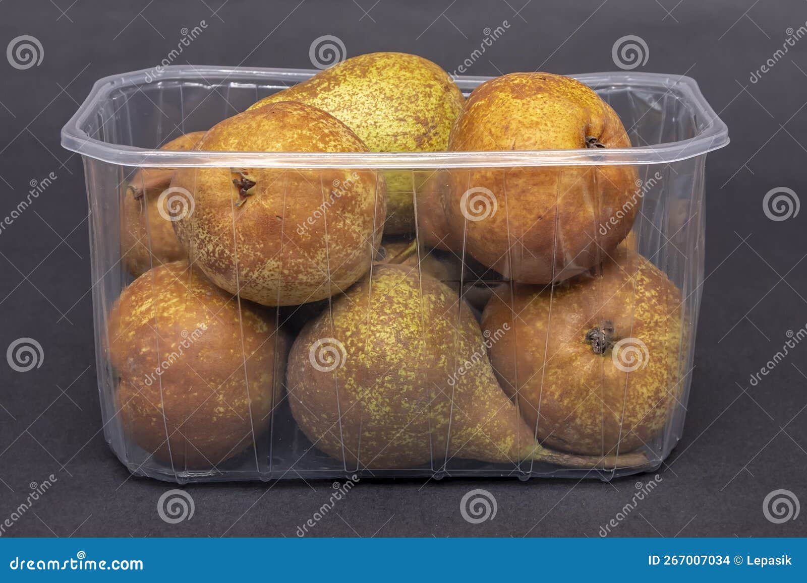 A Bunch of Pears are Lying in a Transparent Plastic Box on a Dark ...
