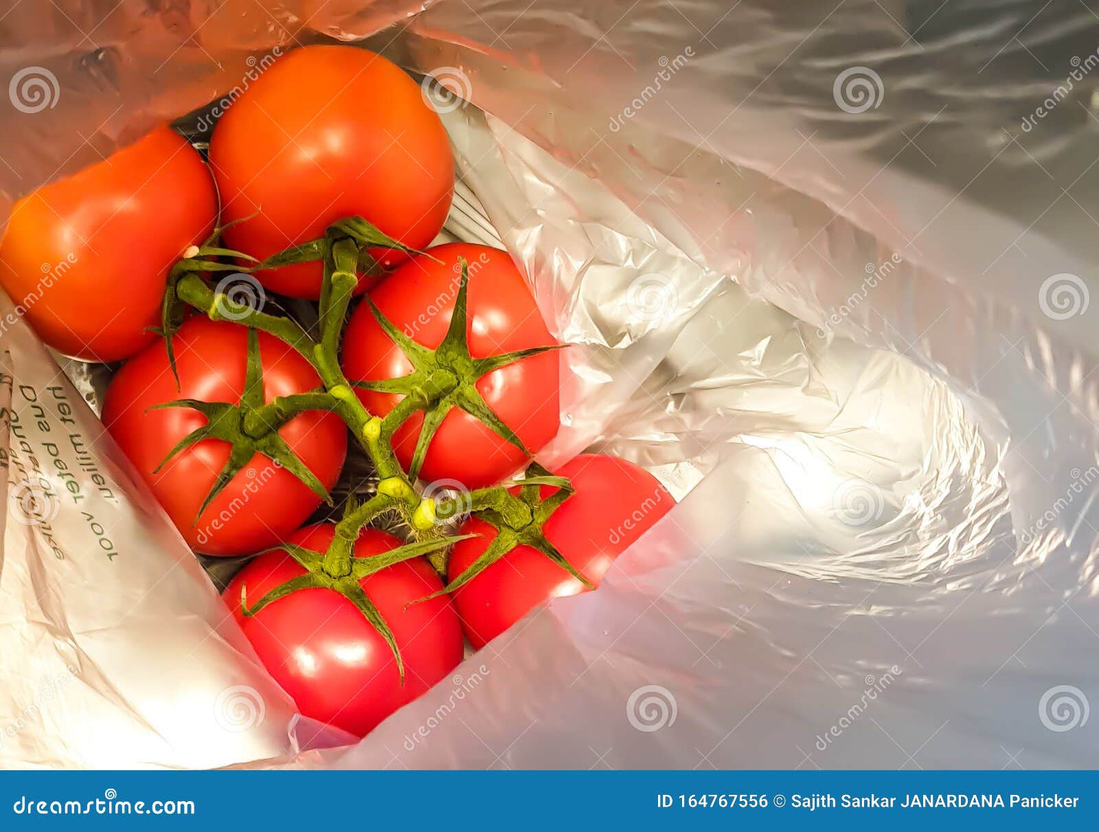 A Bunch of Red Tomatoes Packed in Plastic Stock Photo - Image of ...