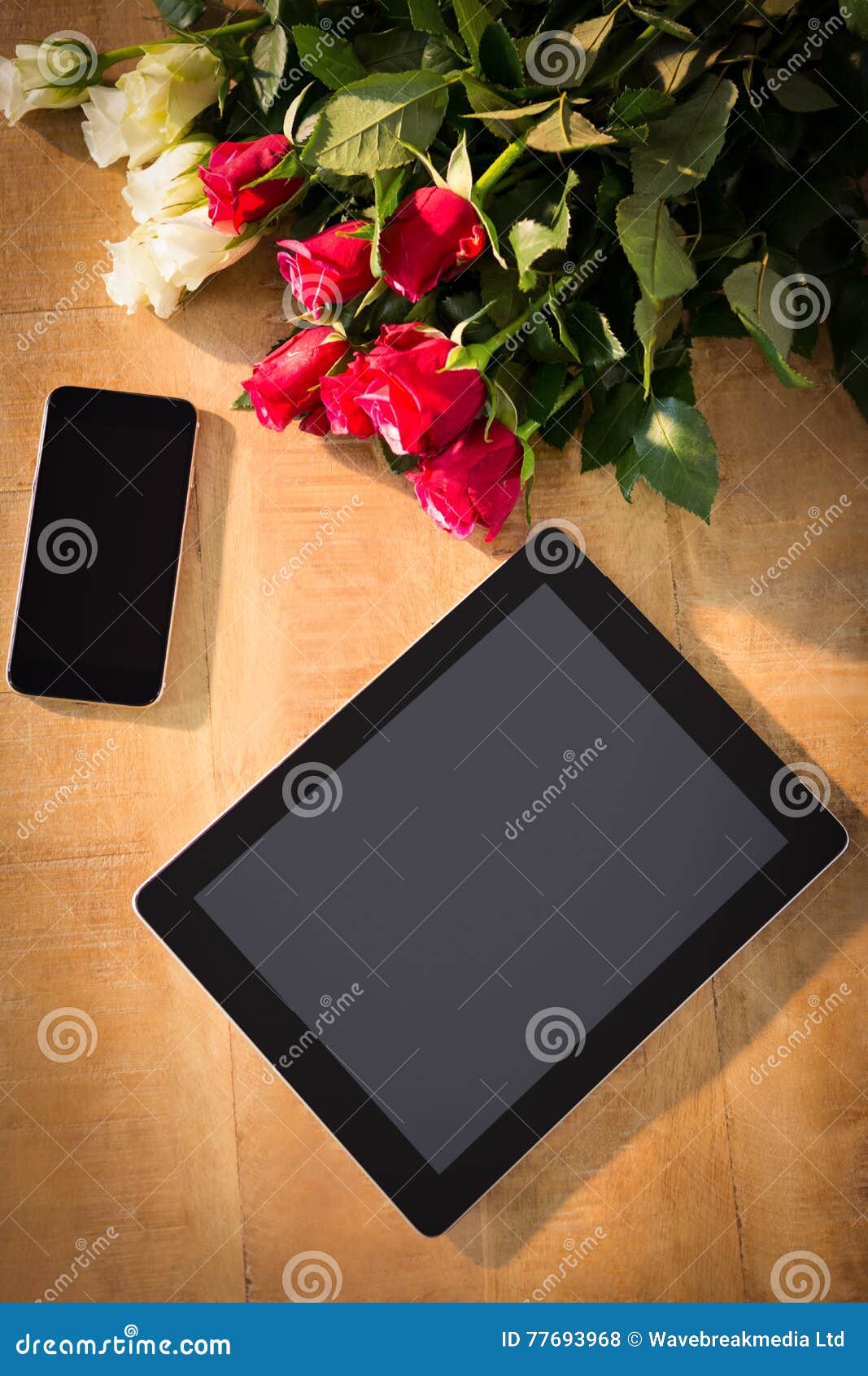 Bunch of Roses with Smartphone and Digital Tablet on the Wooden Table ...
