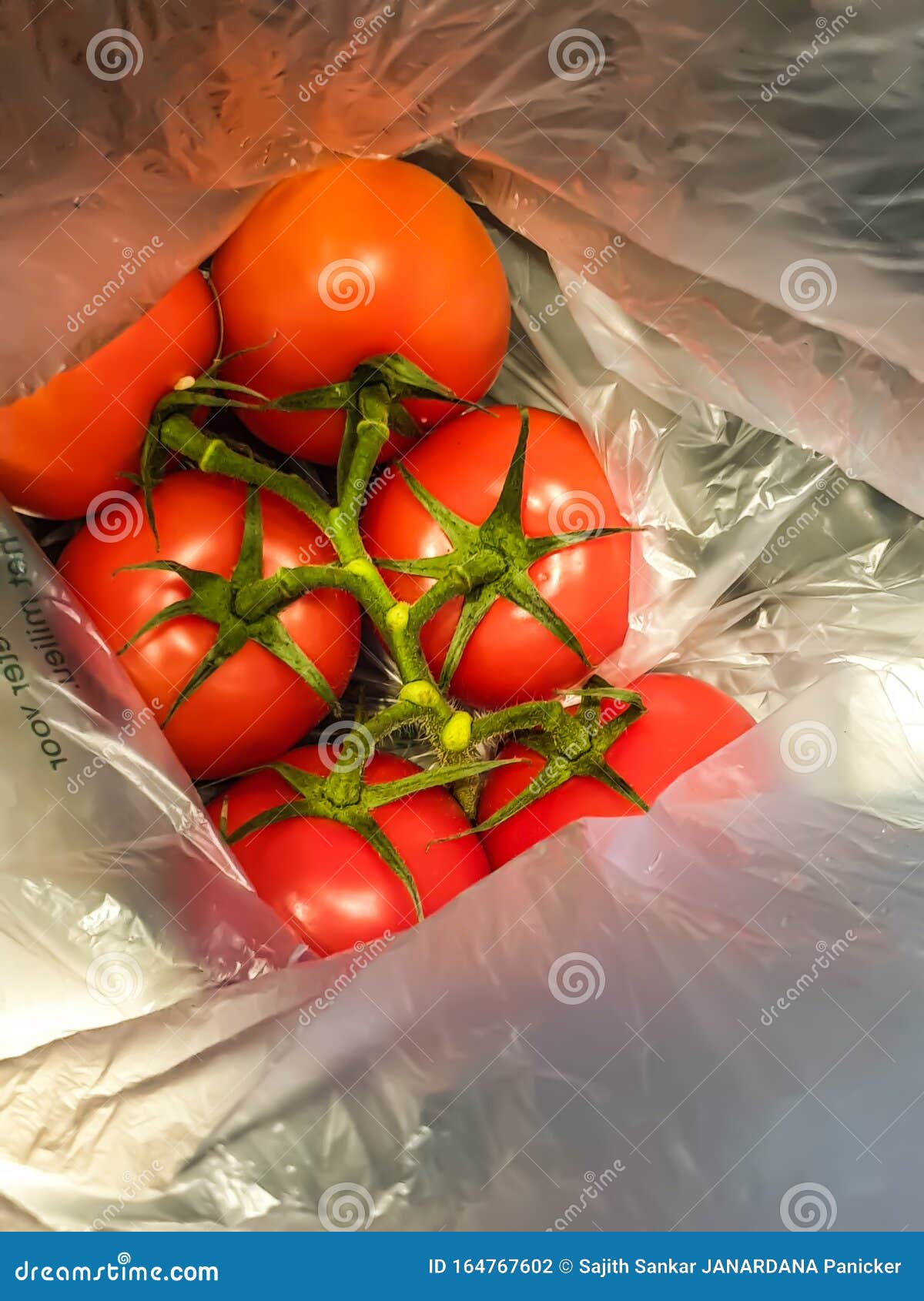 A Bunch of Red Tomatoes Packed in Plastic Stock Photo - Image of ...