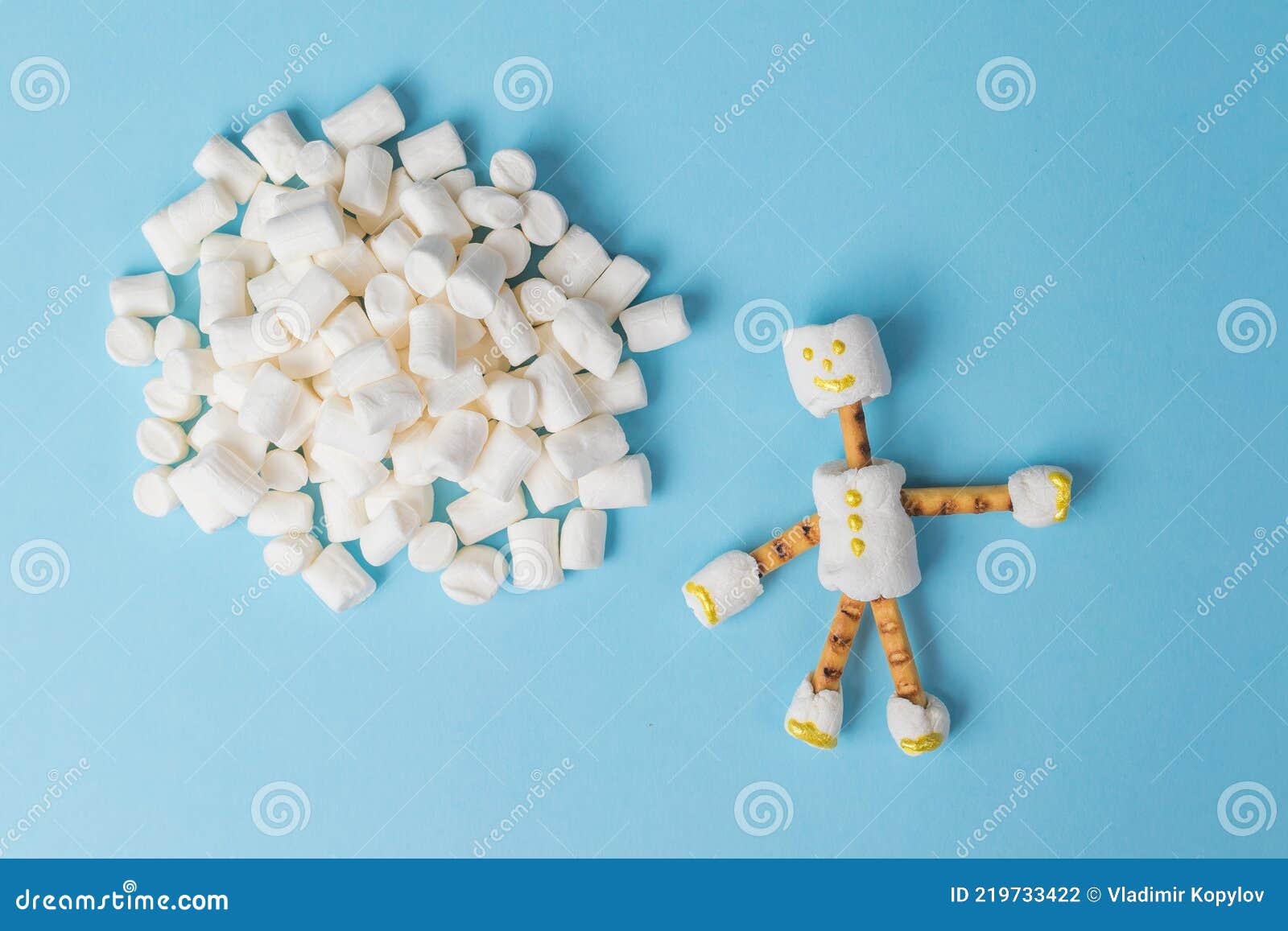 A Bunch of Small Marshmallows and a Man on a Blue Background. Flat Lay ...