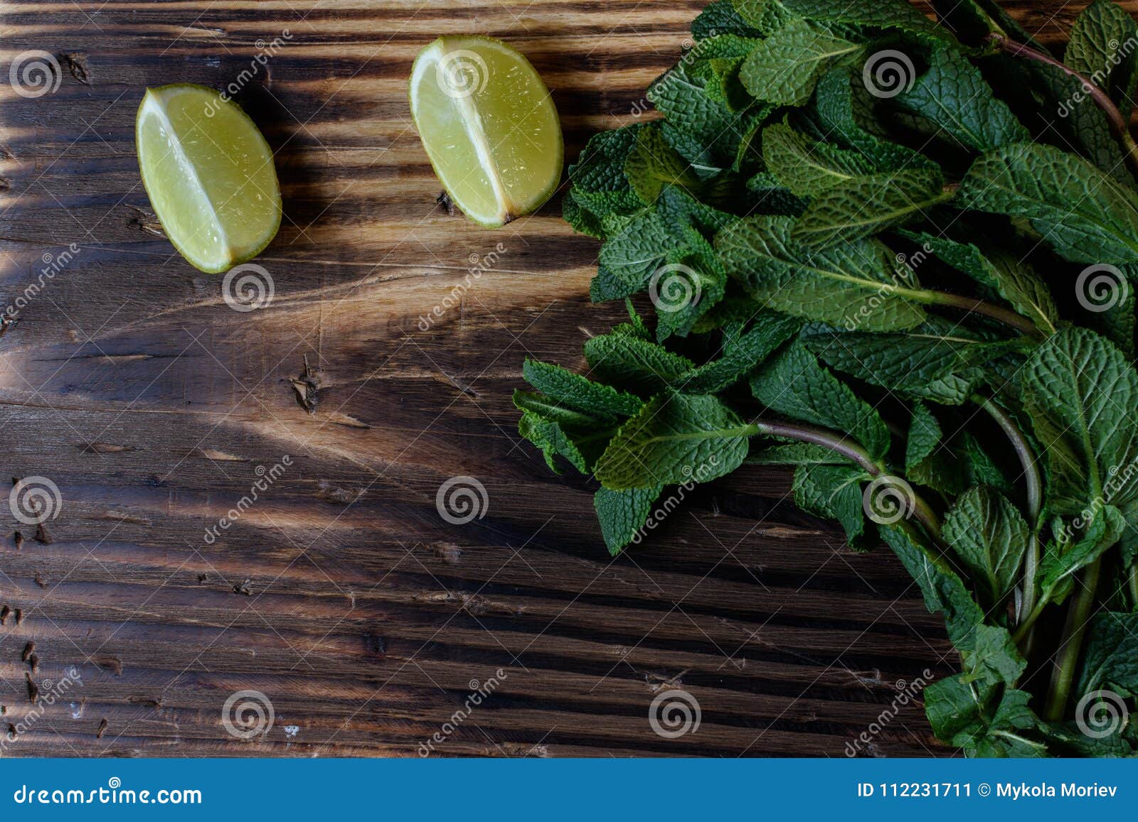 Bundle of Fresh Mint and Lime Slice on a Wooden Background. Stock Image ...