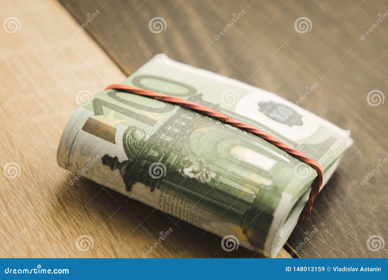 Bundle of Money Folded in Half Lying on a Wooden Table Stock Image ...