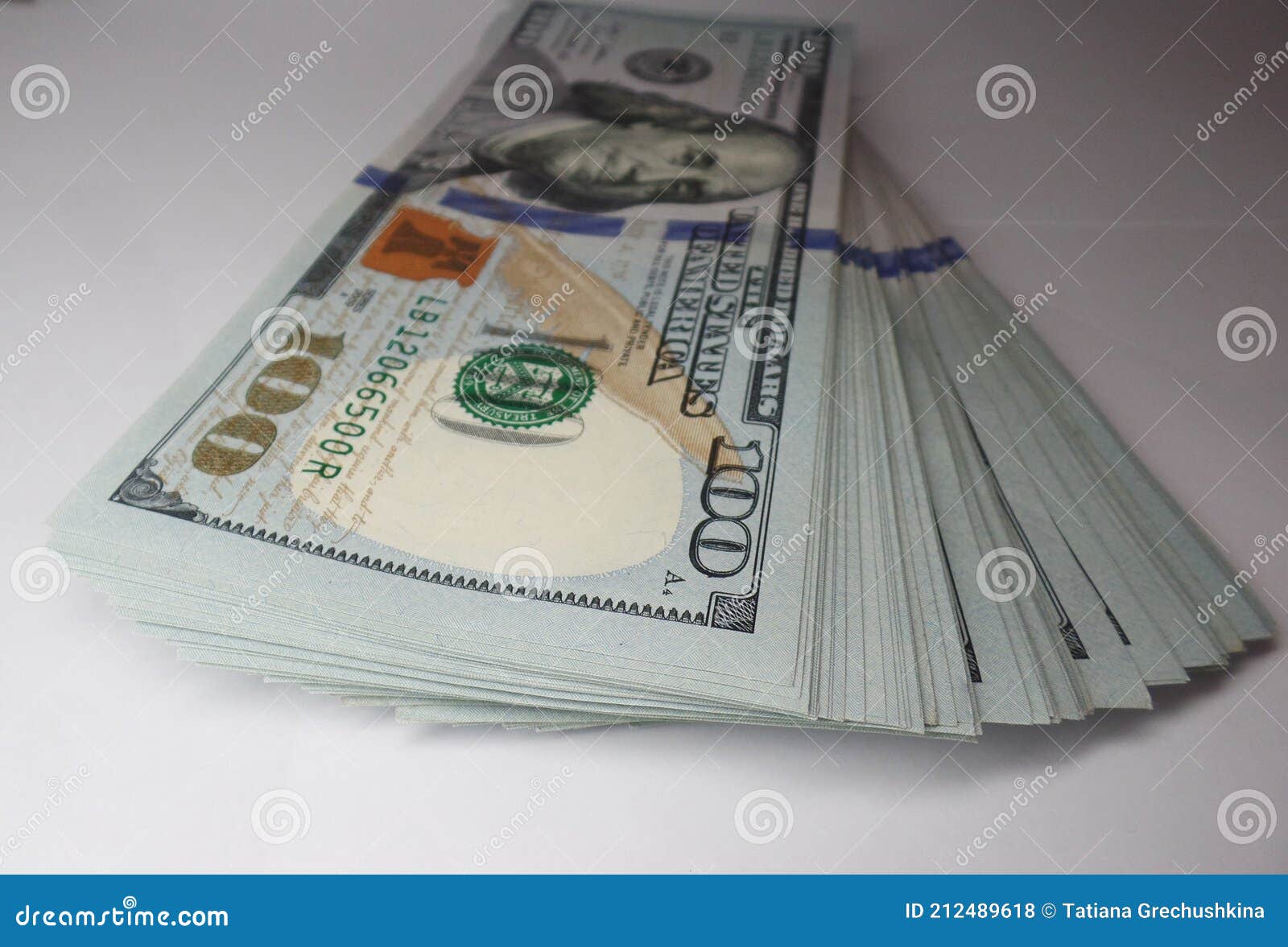 A Bundle of Real Dollars on a White Table Stock Photo - Image of ...