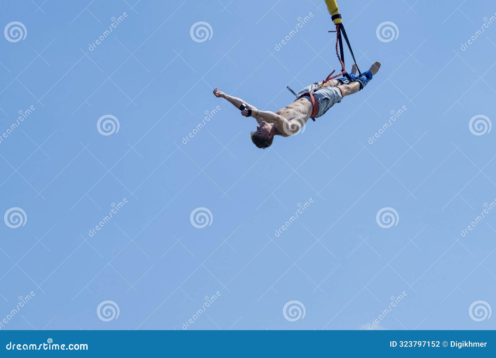 Bungy Jumper Jumping from a Crane Attached with Elastic Rope in the Sky ...