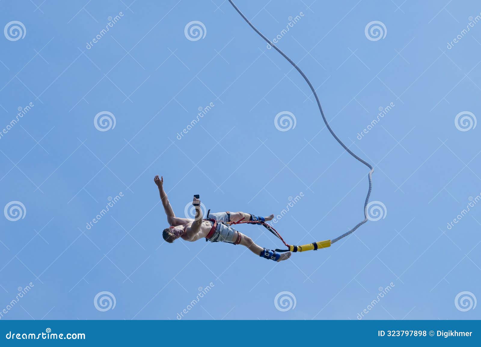 Bungy Jumper Jumping from a Crane Attached with Elastic Rope in the Sky ...