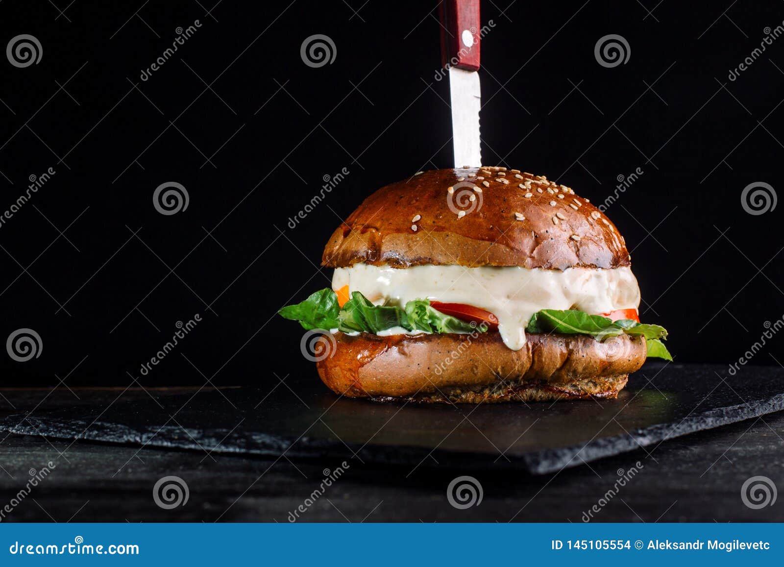 A Burger on the Black Background with an Angle View. Stock Photo ...