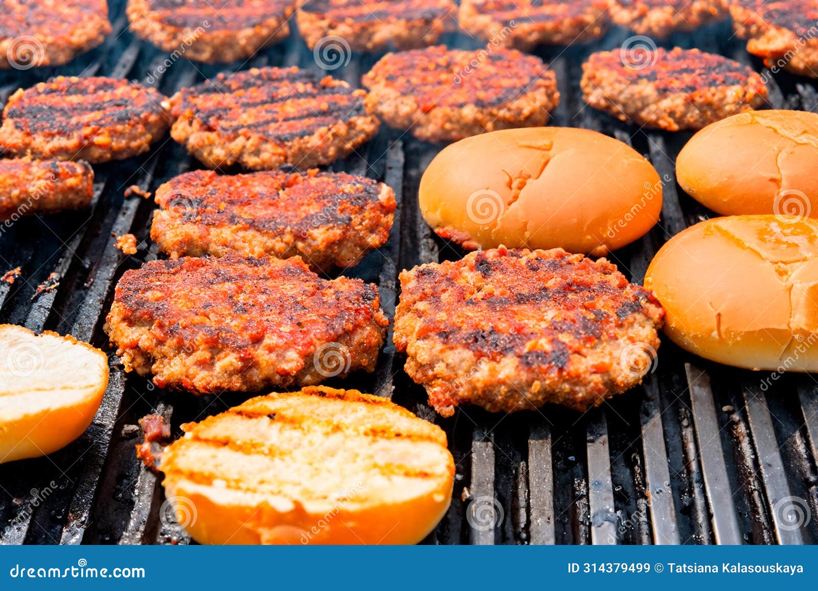 Burger Buns and Patties Grilled on the Grill Barbecue Grate Stock Image ...