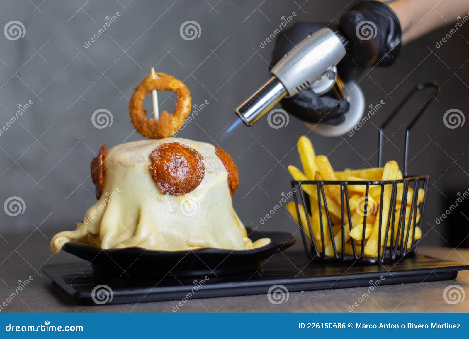 Burger Covered in Melted Cheese with a Fire Gun Stock Photo - Image of ...