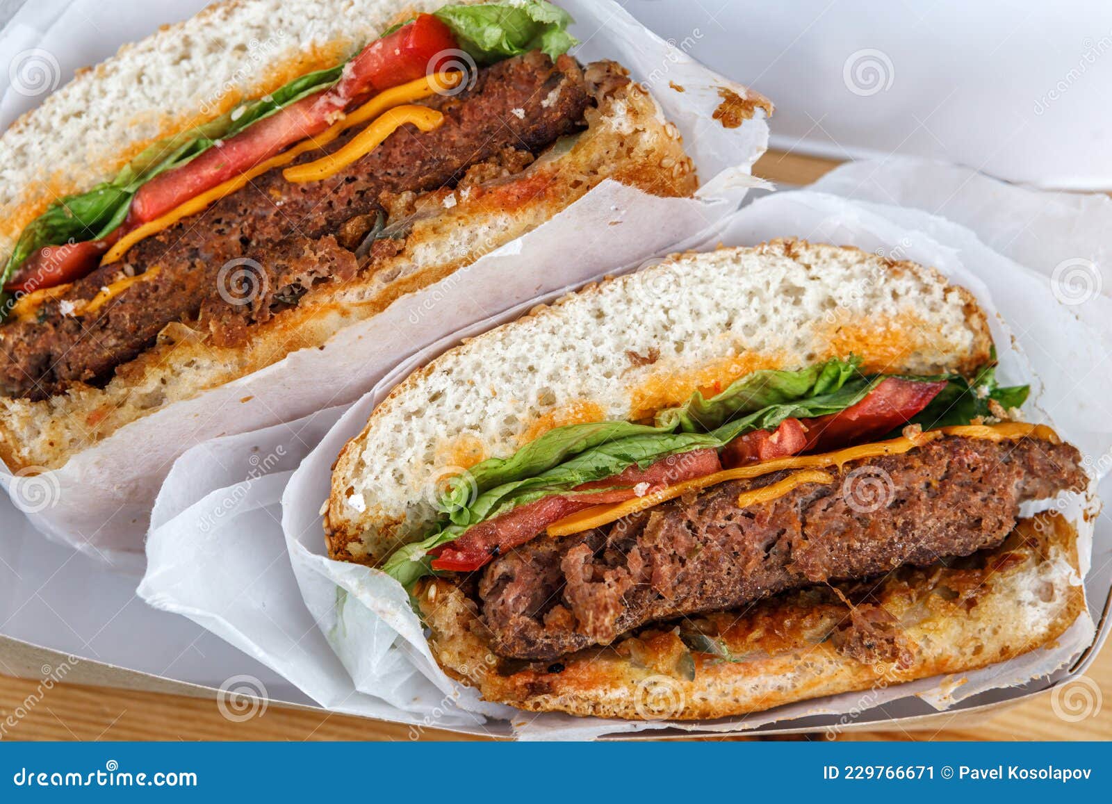 Burger cut into two halves stock image. Image of beef - 229766671
