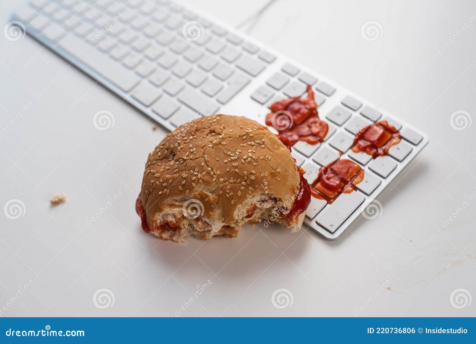 Burger and Drops of Ketchup on Computer Keyboard on White Desktop ...