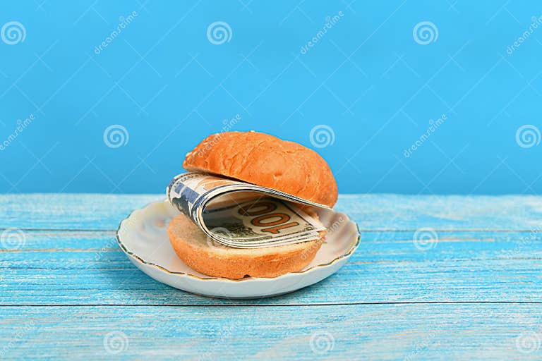 Burger with Money Inside Bread on a Platter on a Blue Background Stock ...