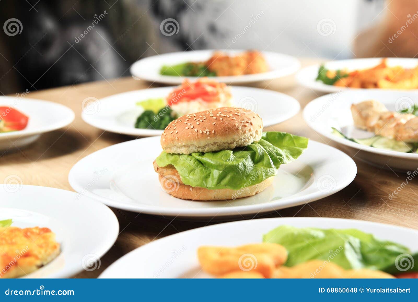 Burger and a Plate of Delicious Dishes on the Table in the Restaurant ...