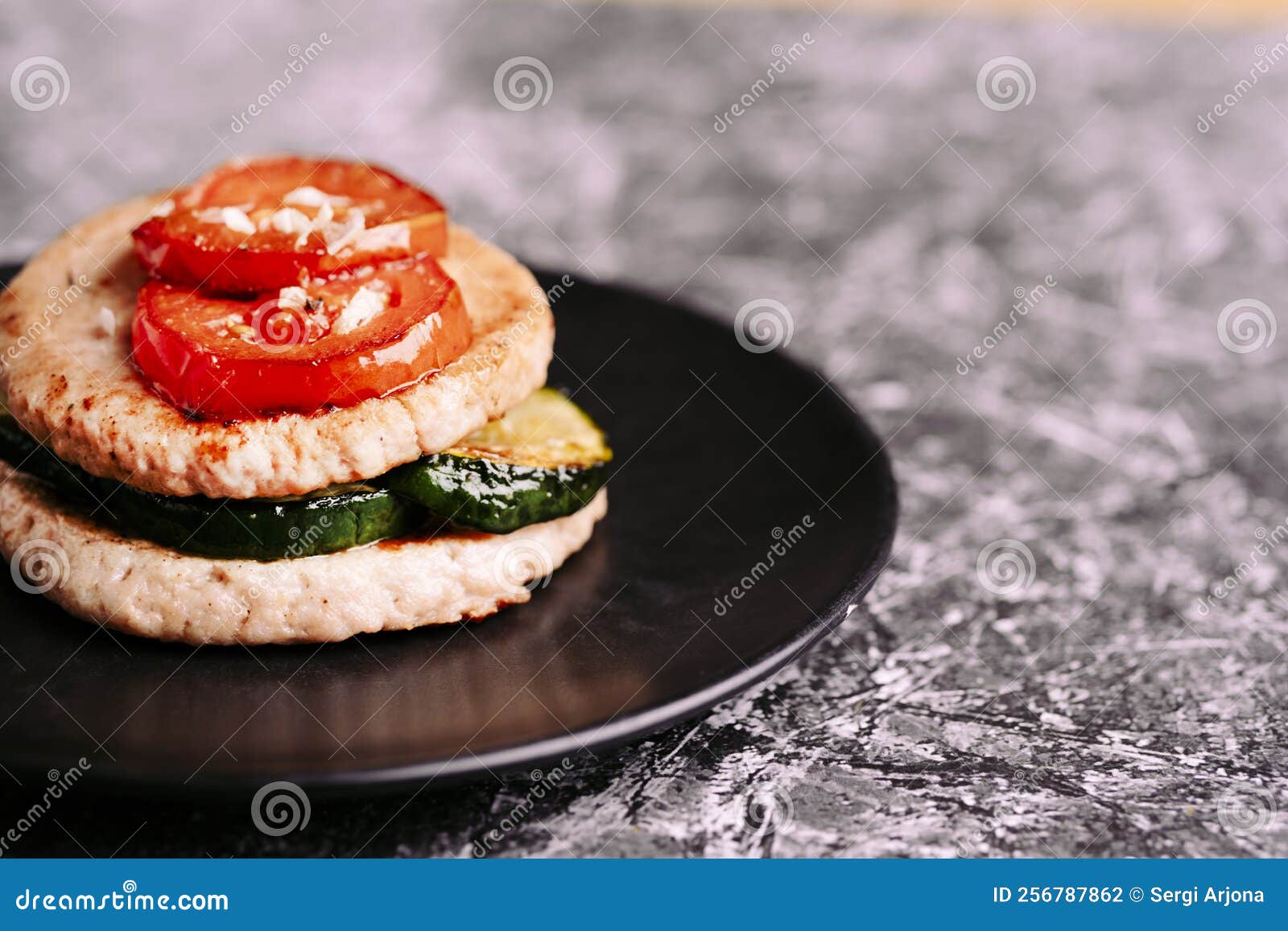 Burger Plate with Grilled Vegetables on a Black Plate Stock Photo ...