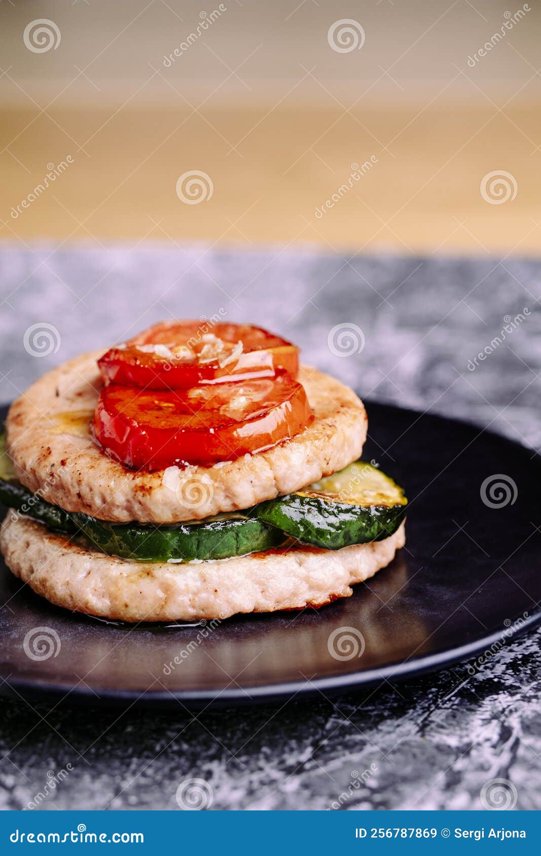 Burger Plate with Grilled Vegetables on a Black Plate Stock Image ...