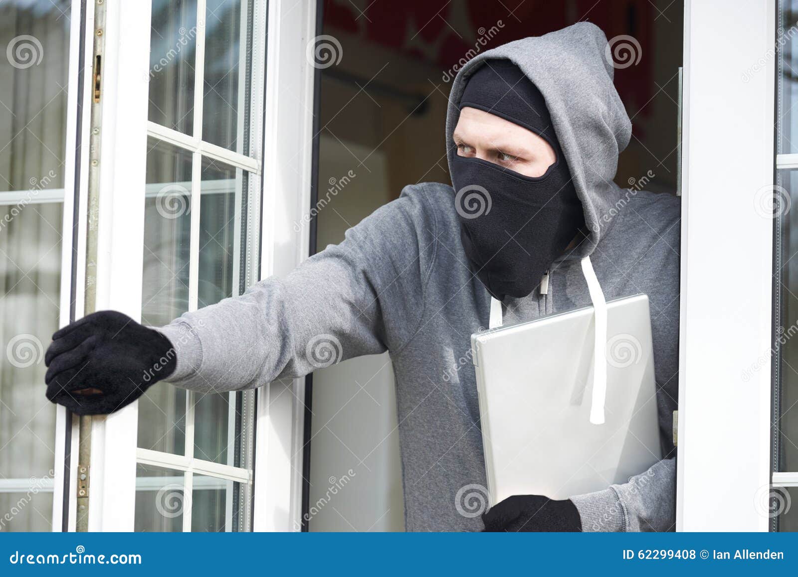 Burglar Breaking into House and Stealing Laptop Computer Stock Photo ...