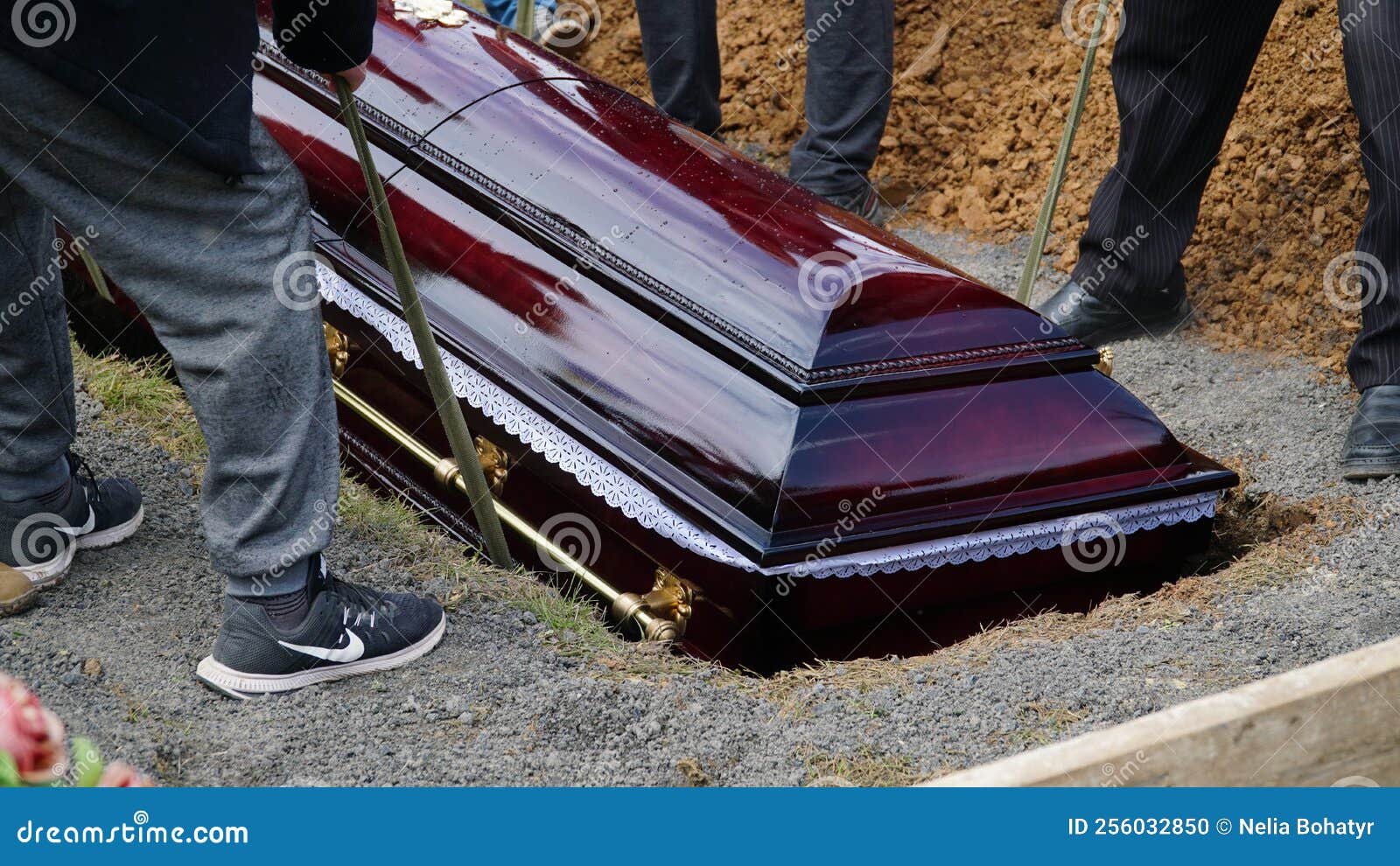 Burial. Men Lower the Coffin into the Grave. N Stock Photo - Image of ...