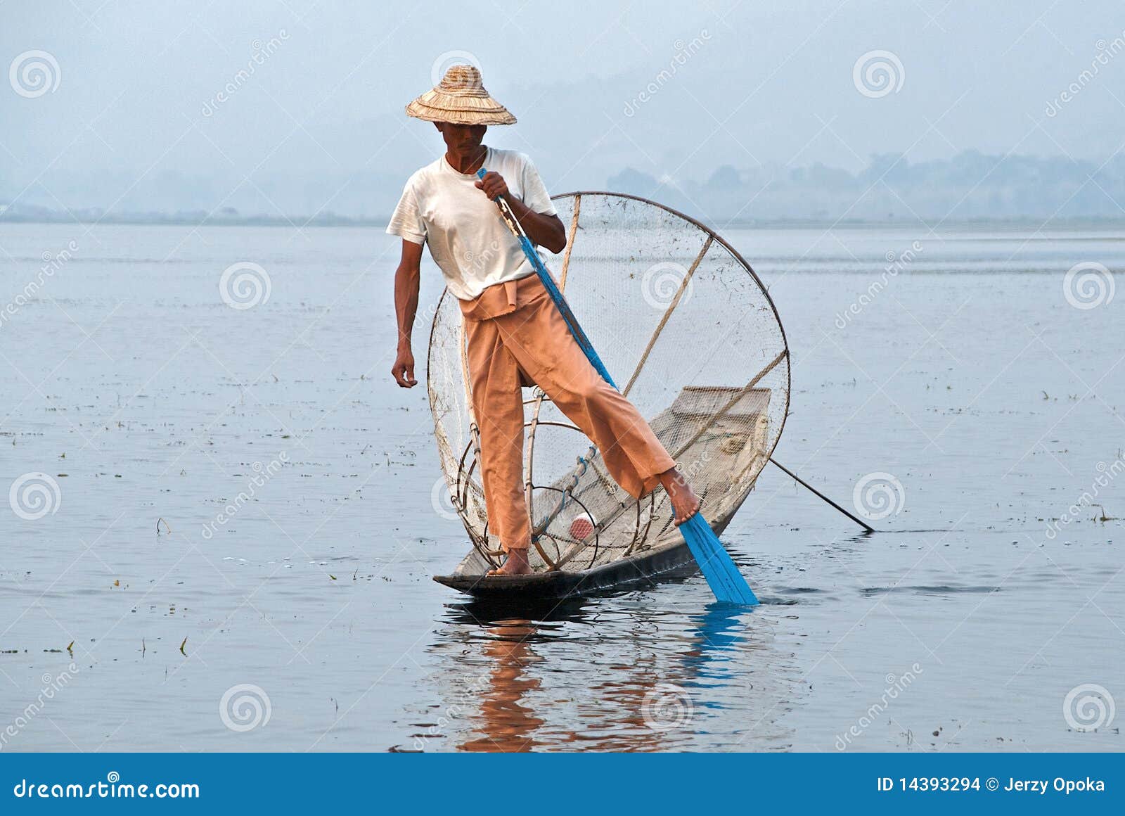 Burmese Fisherman Leaning On Oar Posing In Traditional Clothes With ...