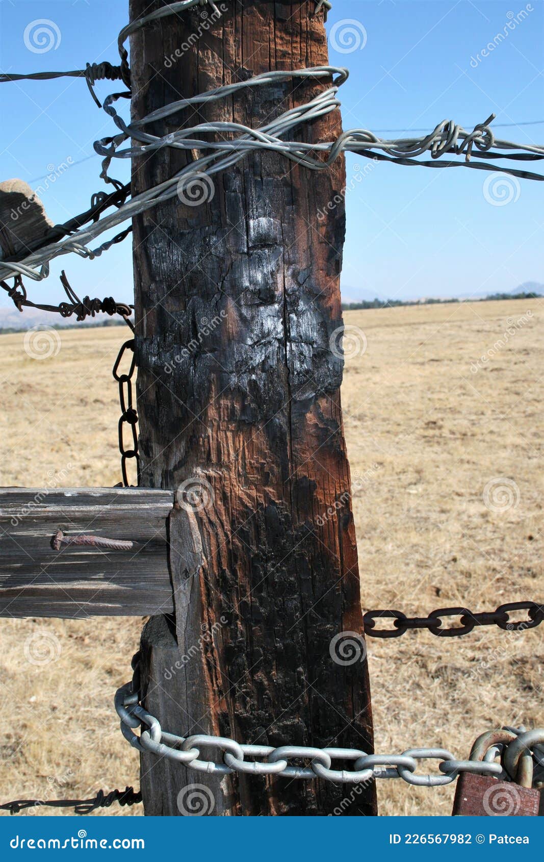 Burned Fence Post Wire and Chain Stock Photo - Image of chainlink ...