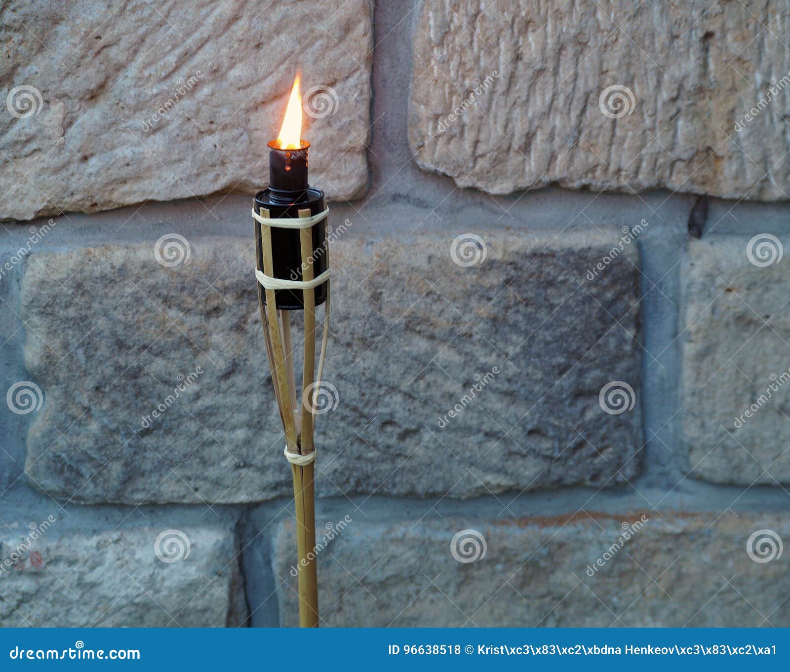 Burning Bamboo Torch on the Sandstone Wall Background Stock Photo ...