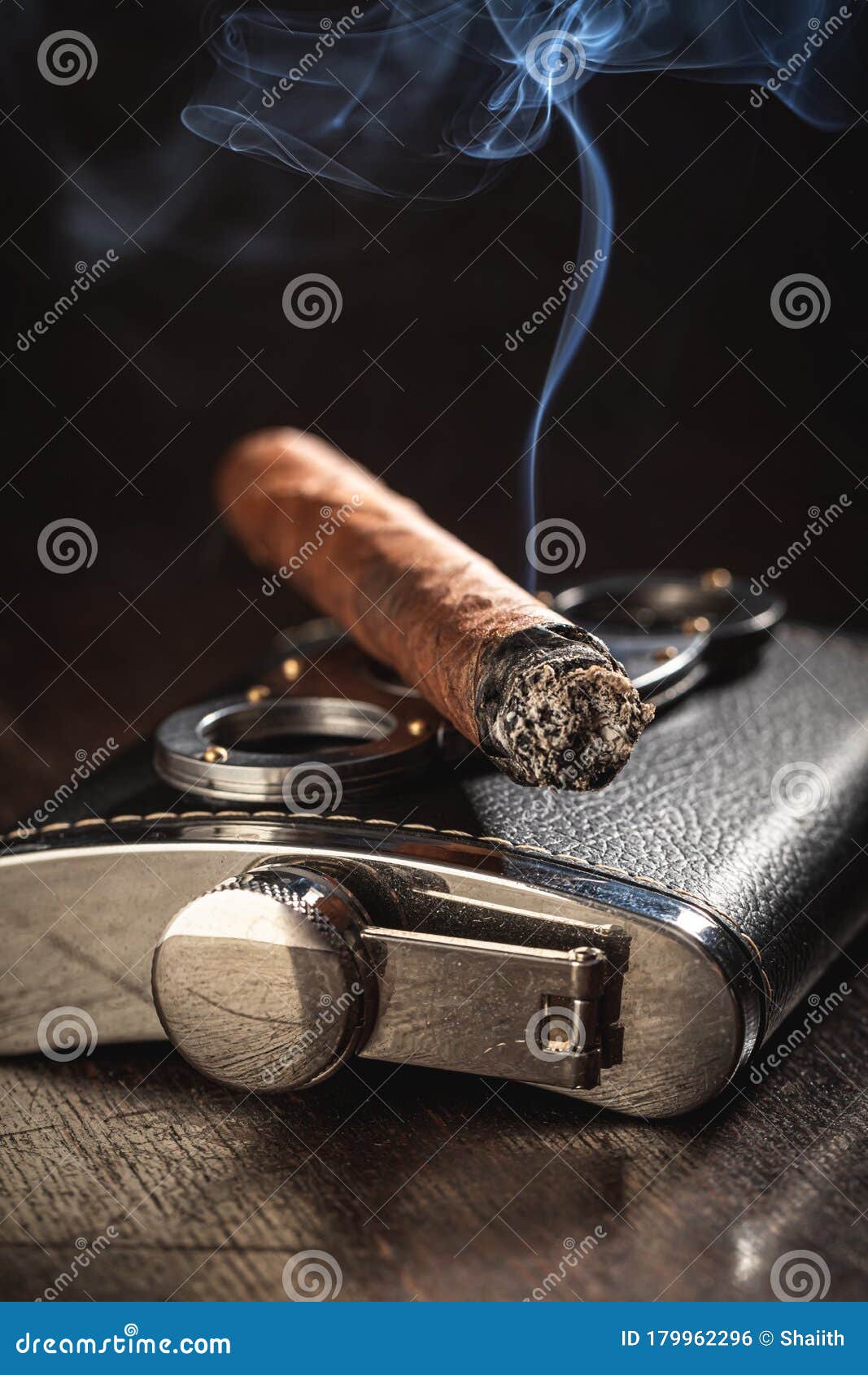 Burning Cigar on Luxury Leather Hip-flask on Black Background Stock ...