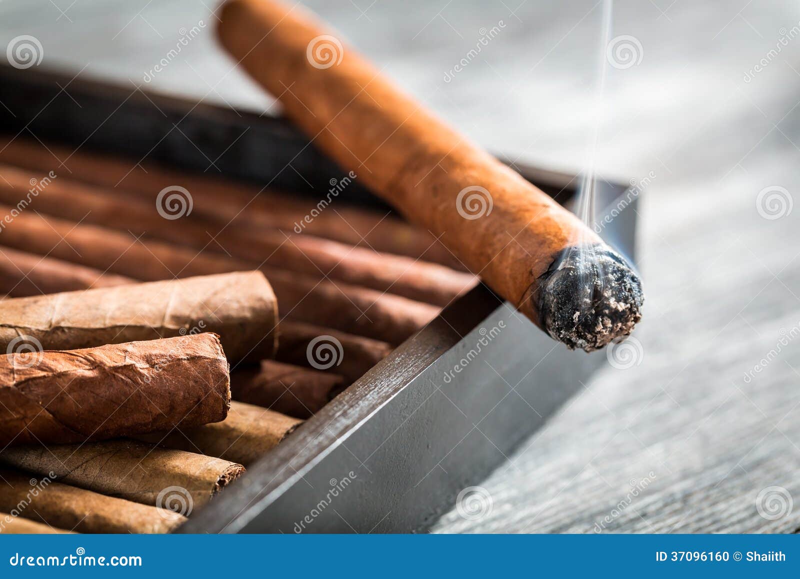 Burning Cigar with Smoke on Wooden Humidor Stock Photo - Image of ...