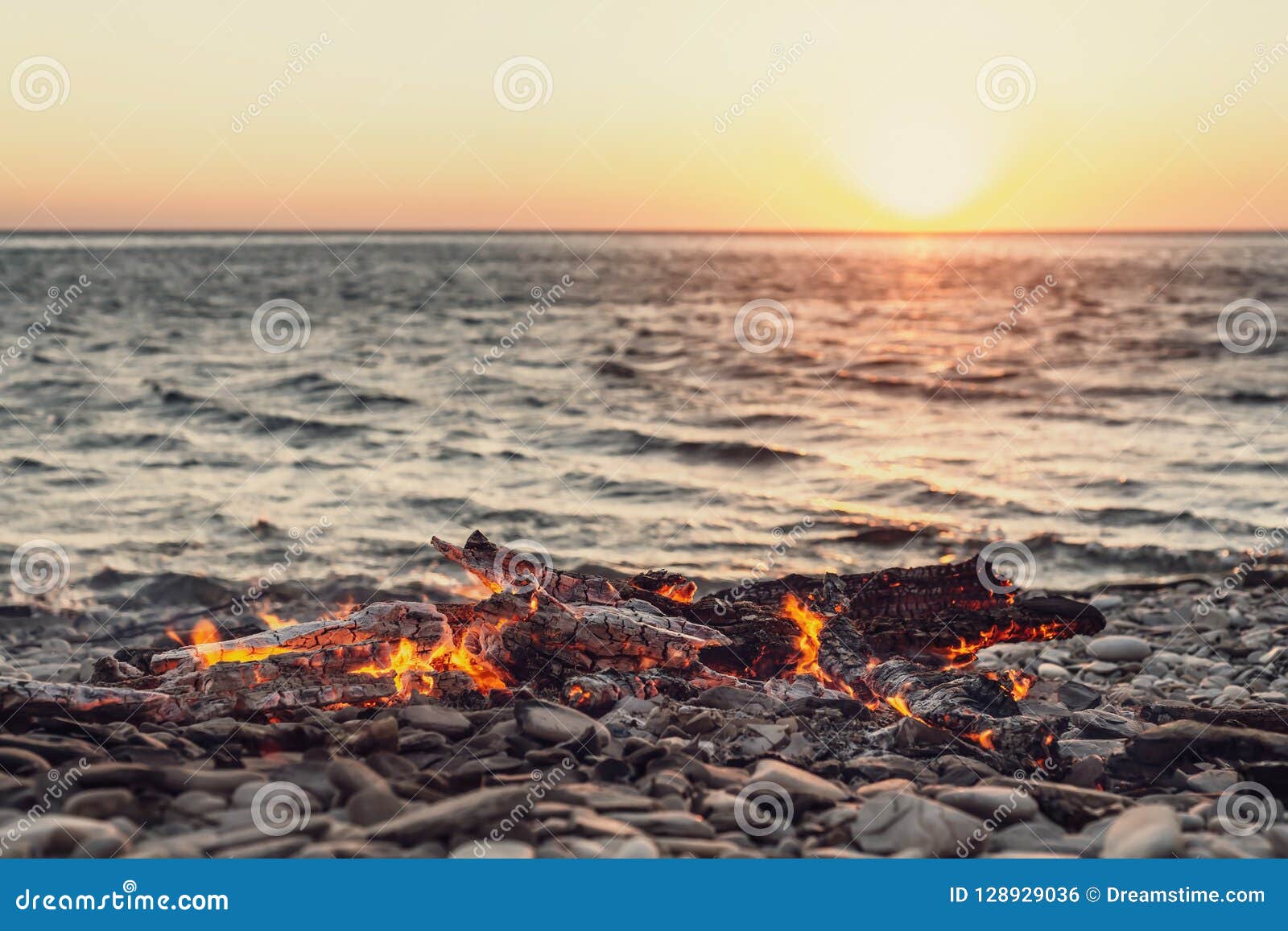 Burning fire at sunset stock photo. Image of outdoors - 128929036