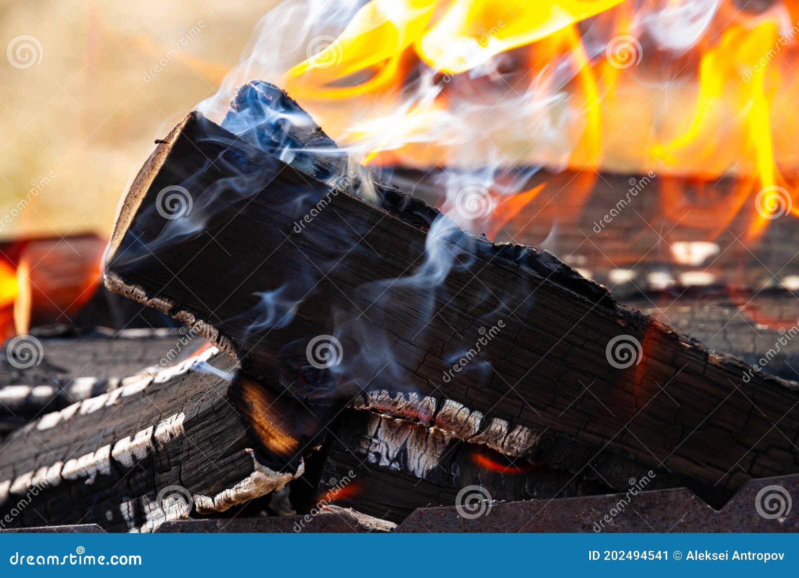 Firewood Stacked in a Bonfire with Coals in the Open Air and Red Flames ...