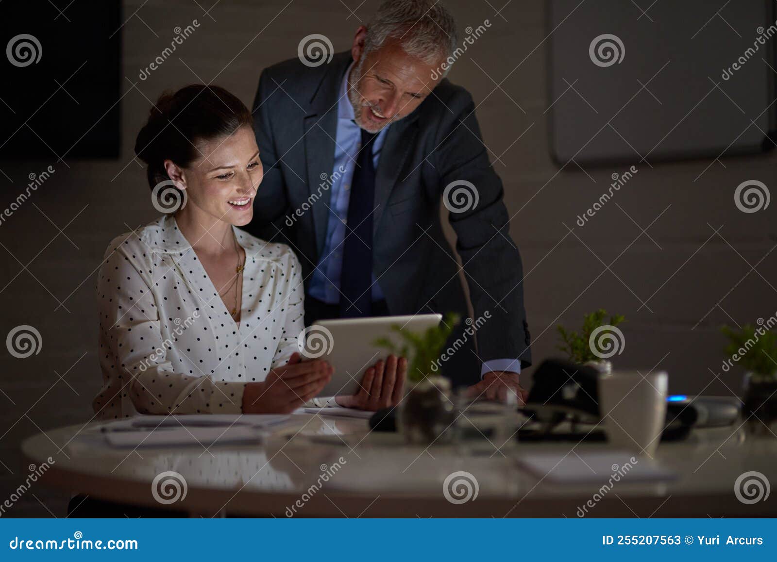Burning the Midnight Iol in the Office. Two Colleagues Using a Digital ...