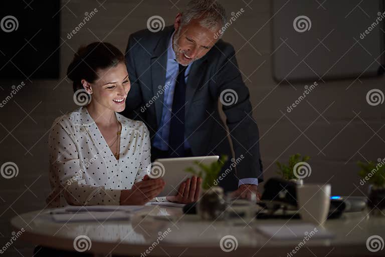 Burning the Midnight Iol in the Office. Two Colleagues Using a Digital ...