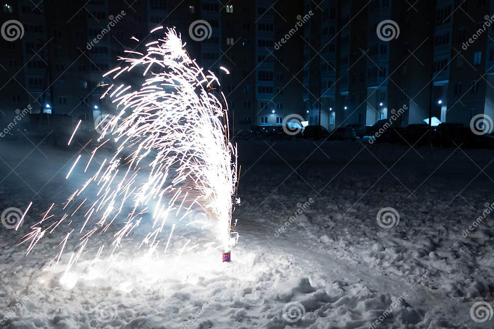 Burning Mini Fireworks in the Snow on a Winter Evening Stock Photo ...