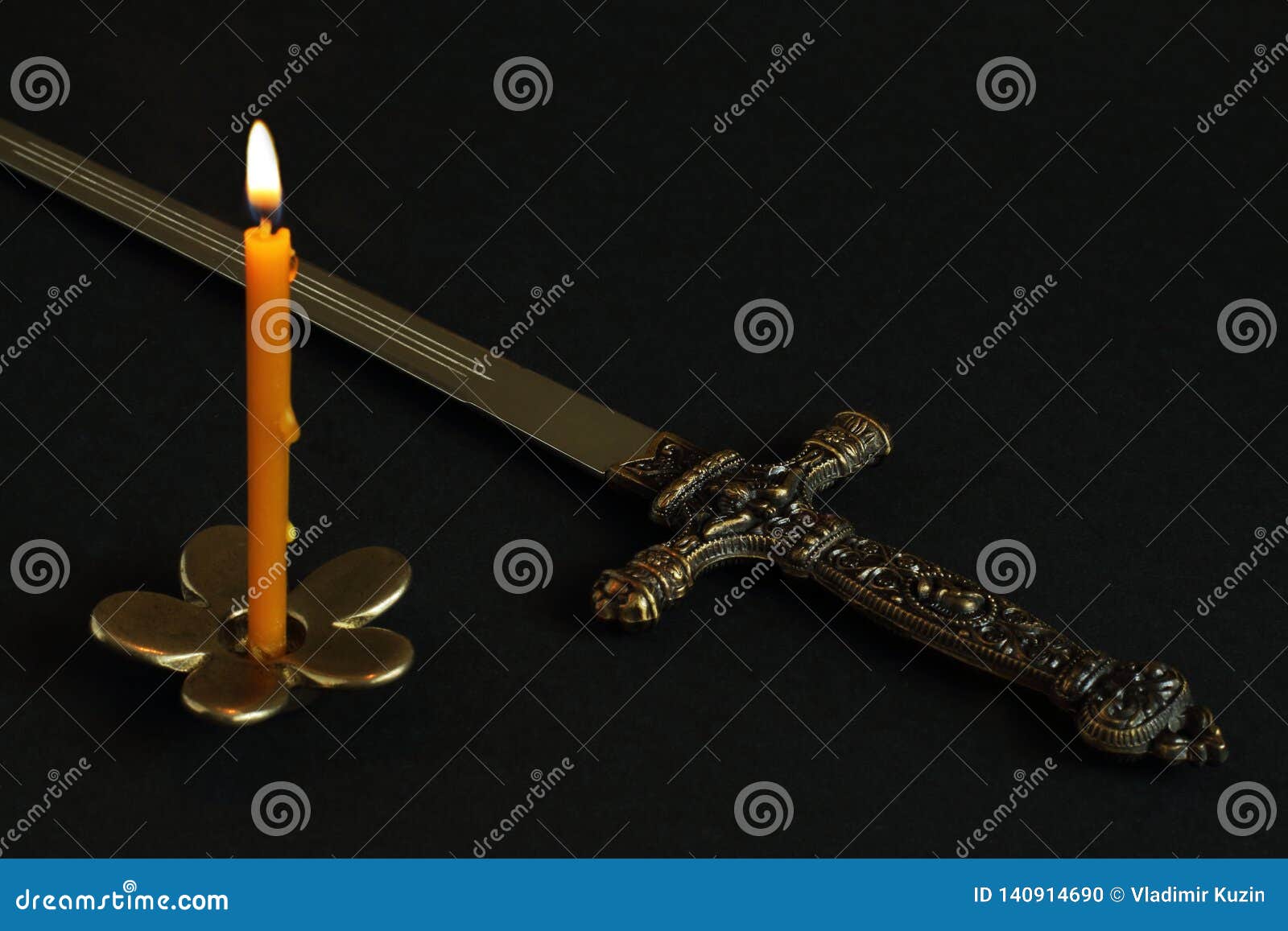 Burning Wax Candle on Bronze Candlestick in Shape of Flower and Dagger ...