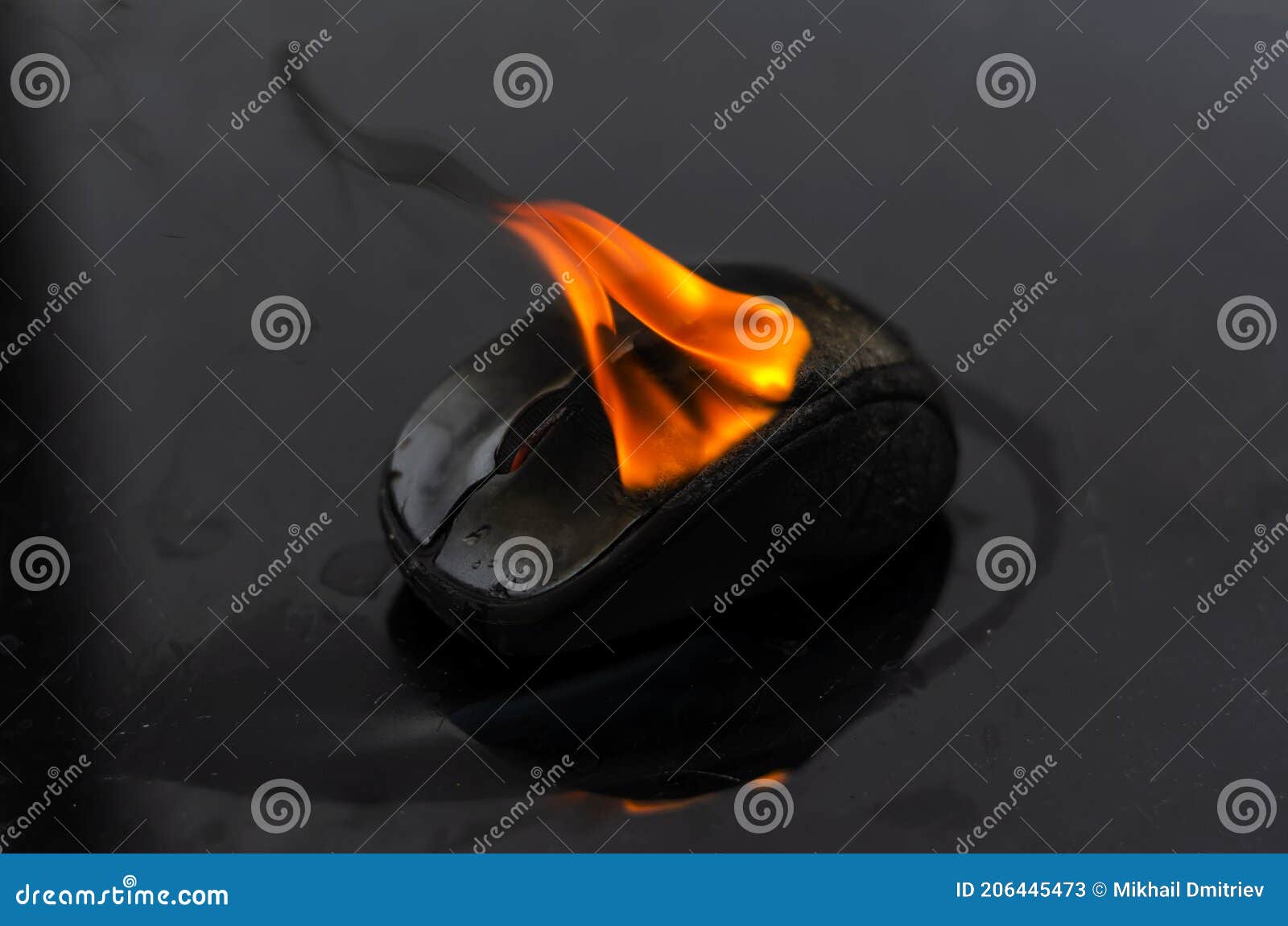 Burning Wireless Computer Mouse on a Black Table Stock Image - Image of ...
