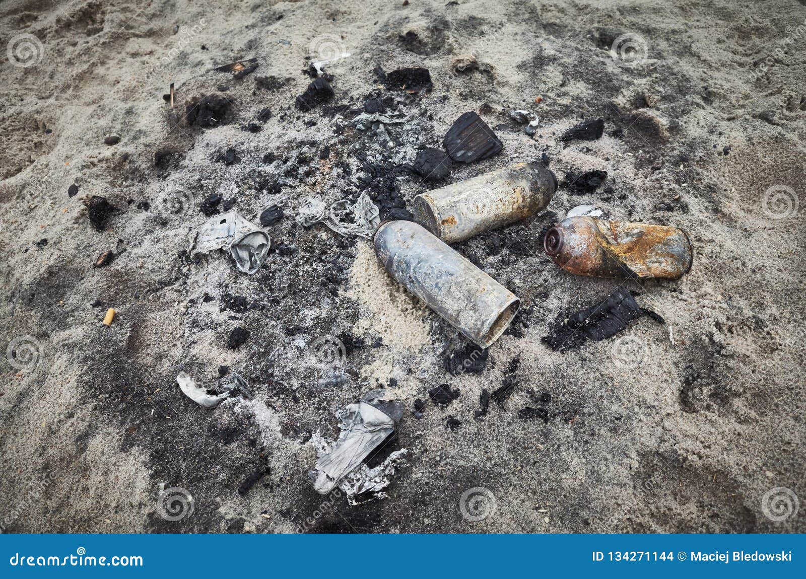 Burnt cans on sand stock photo. Image of beach, pollution - 134271144