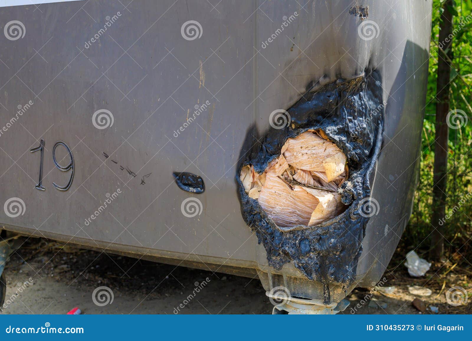 A Burnt Hole in a Plastic Trash Can or Bin. Background with Selective ...