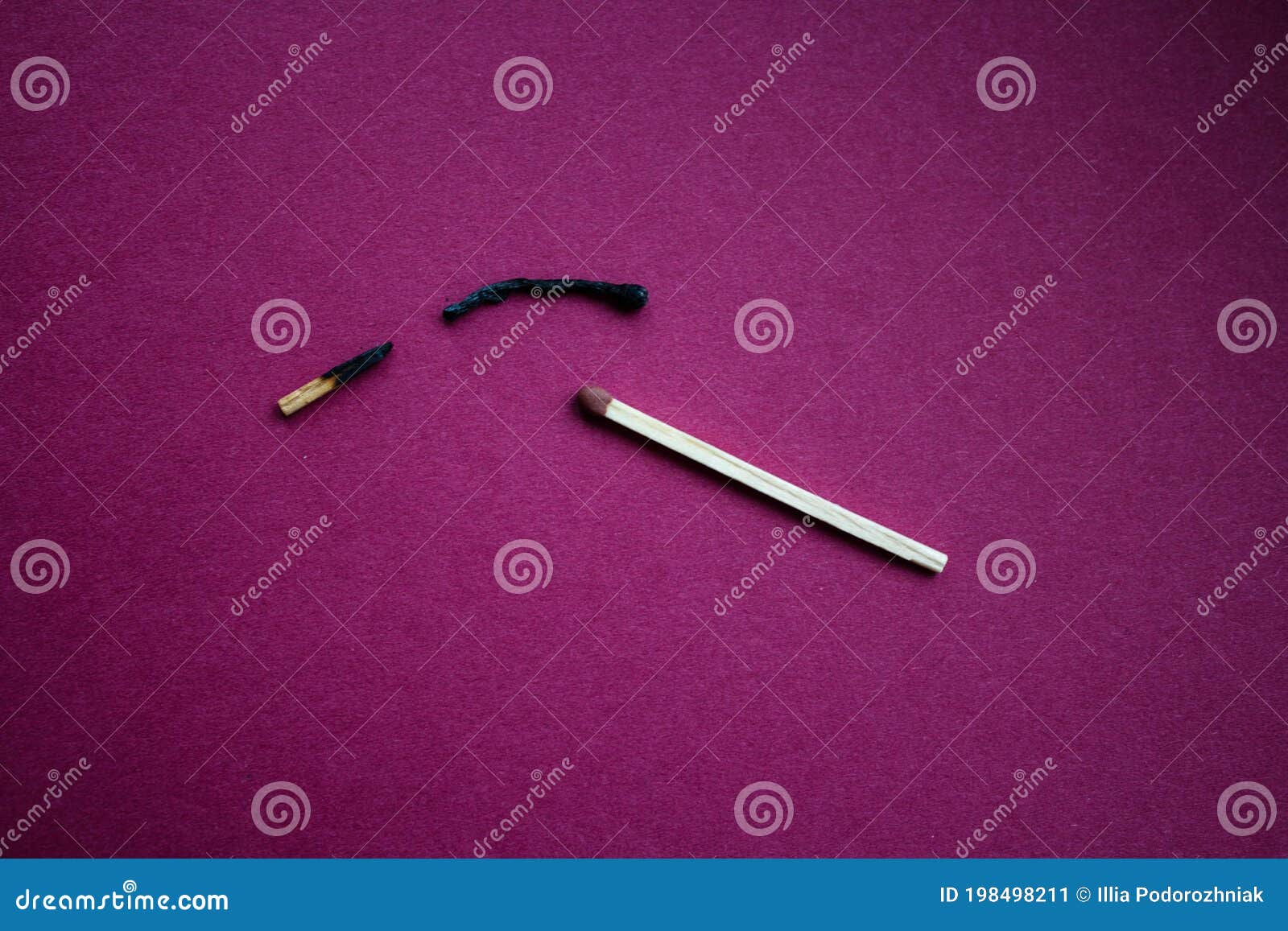 A Burnt Match Broken in Half and Whole Match on Purple Background Stock ...