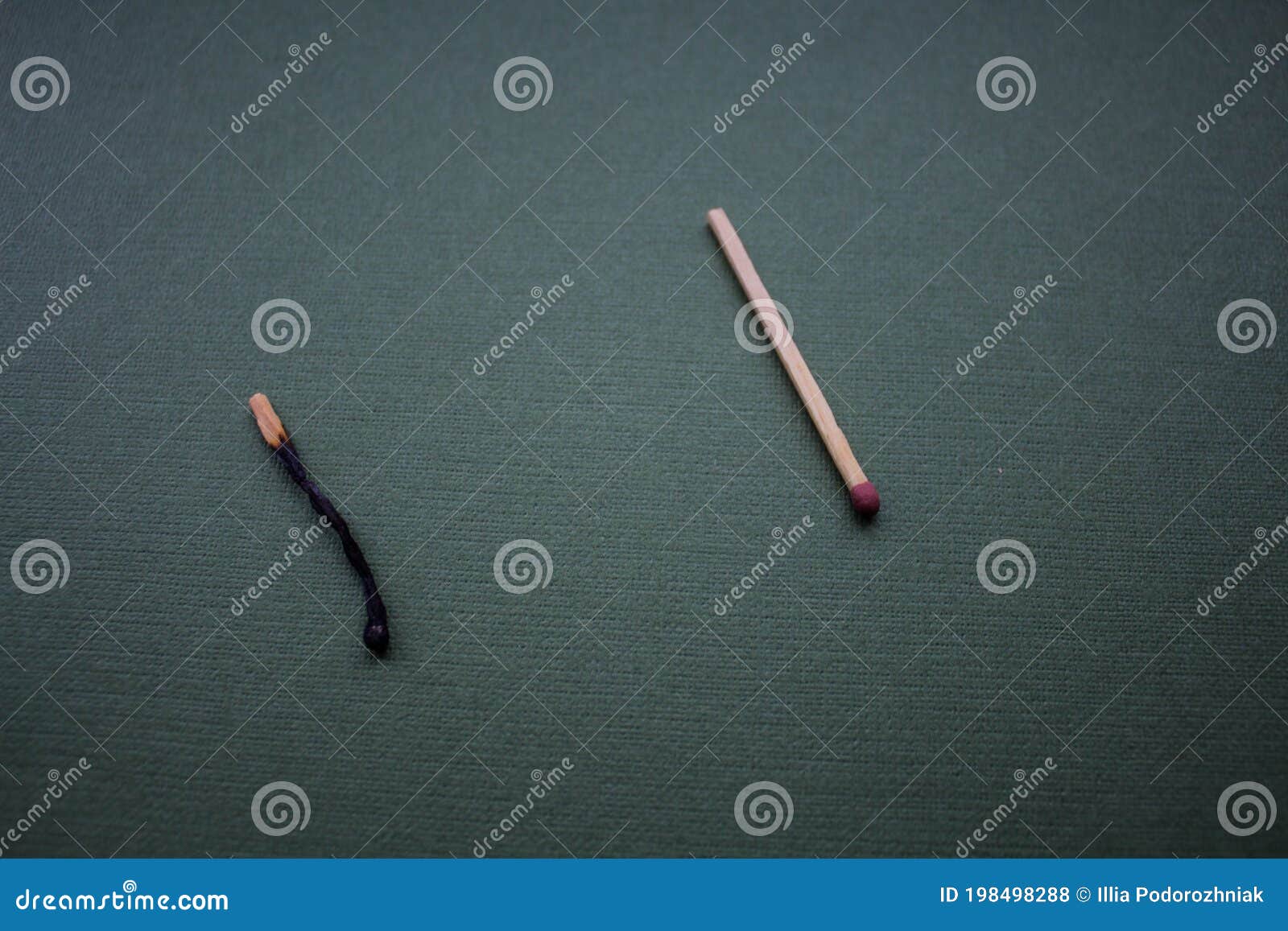 A Burnt Match and Whole Match on Green Background Stock Photo - Image ...