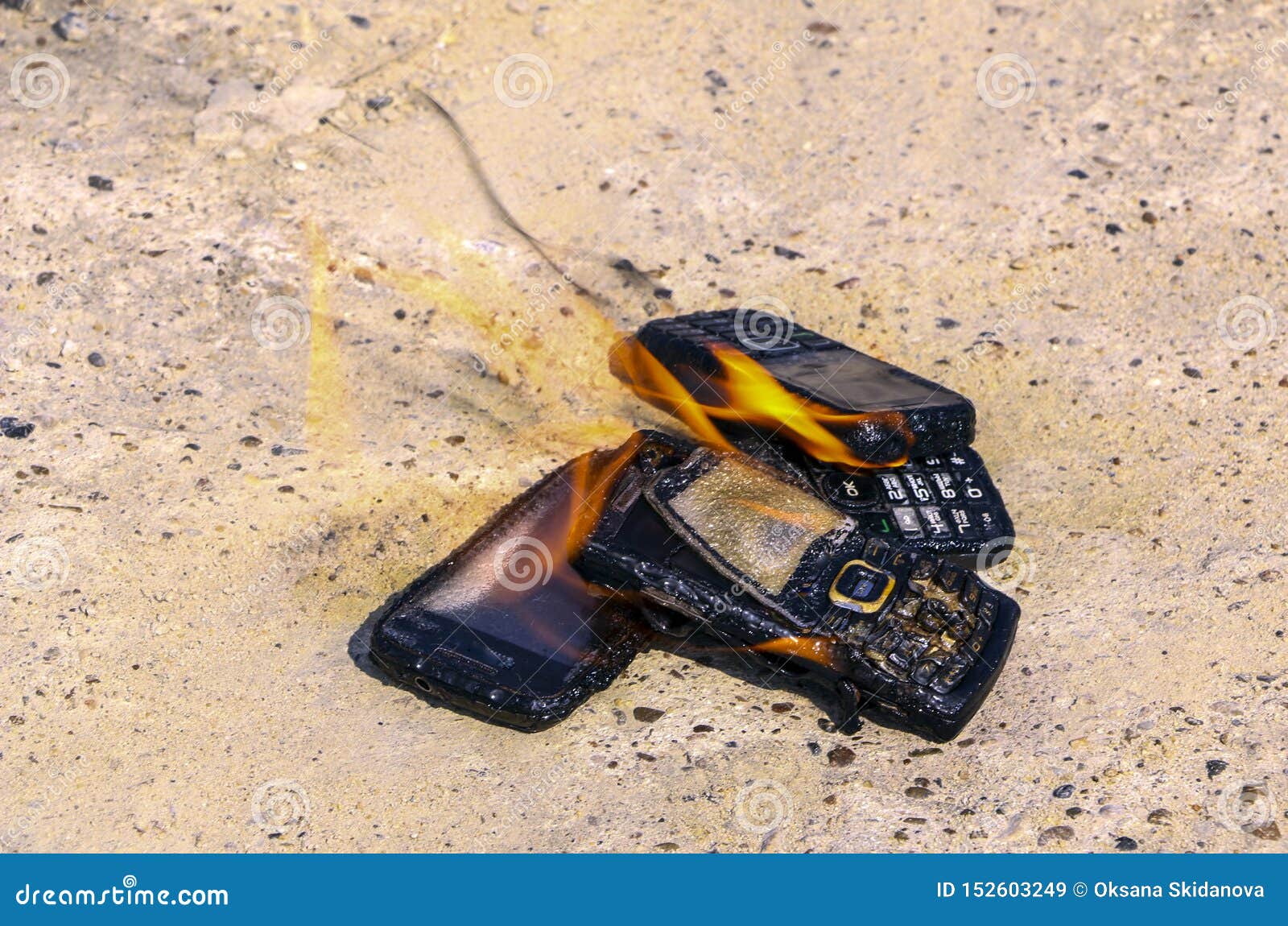 Burnt Mobile Phones on Textural Concrete Background. Concept: Danger of ...