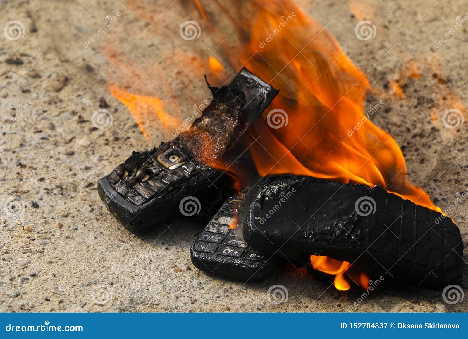 Burnt Mobile Phones on Textural Concrete Background. Concept: Danger of ...