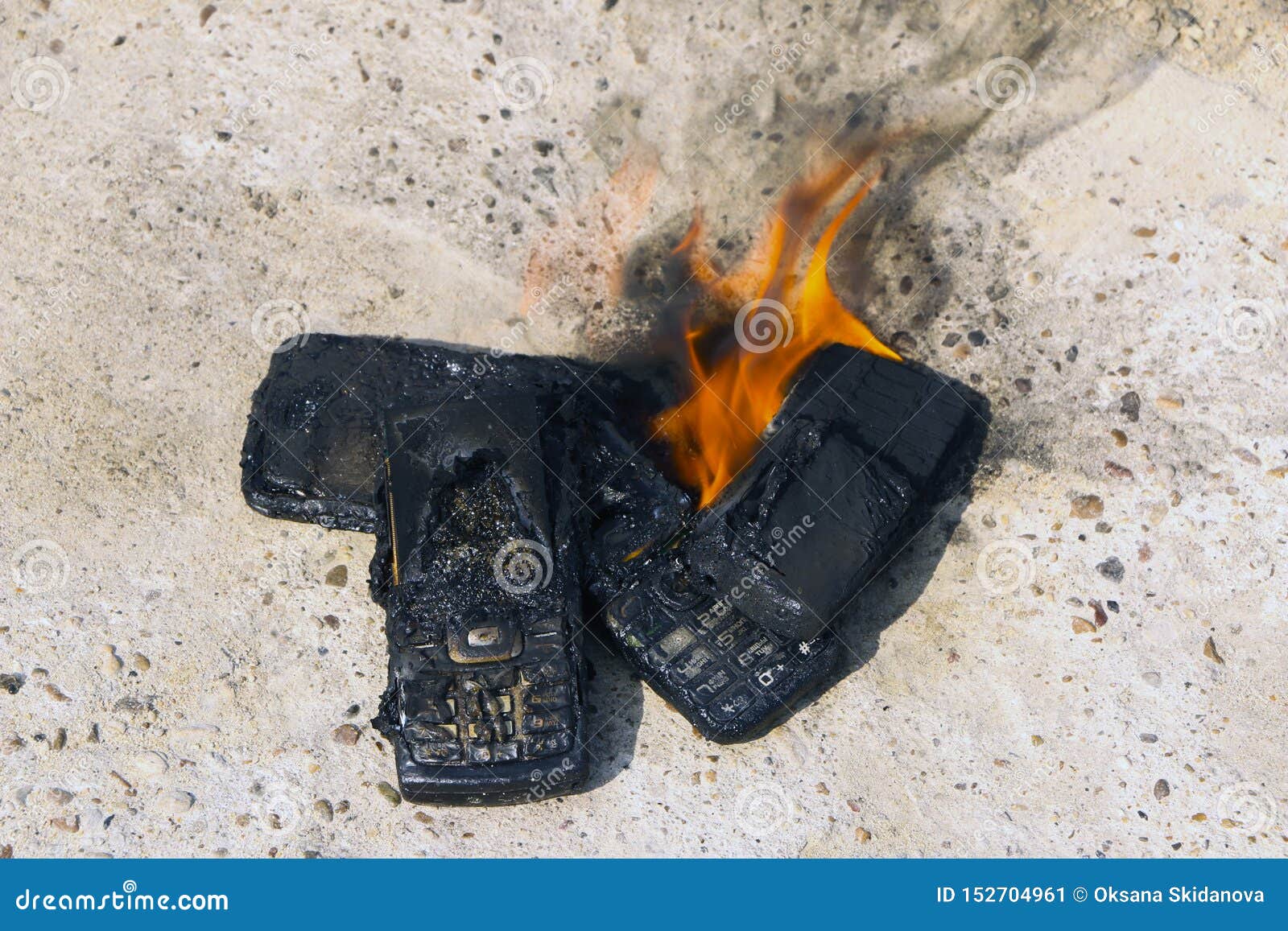Burnt Mobile Phones on Textural Concrete Background. Concept: Danger of ...
