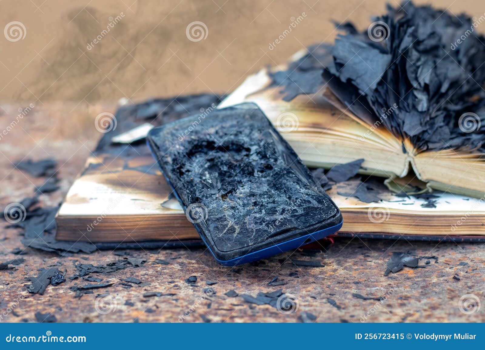 A Burnt Phone and Burnt Books in the Smoke after a Fire Stock Image ...