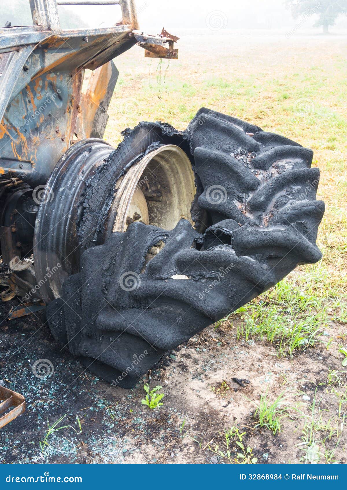 Burnt wheel of tractor stock photo. Image of dented, meadow - 32868984