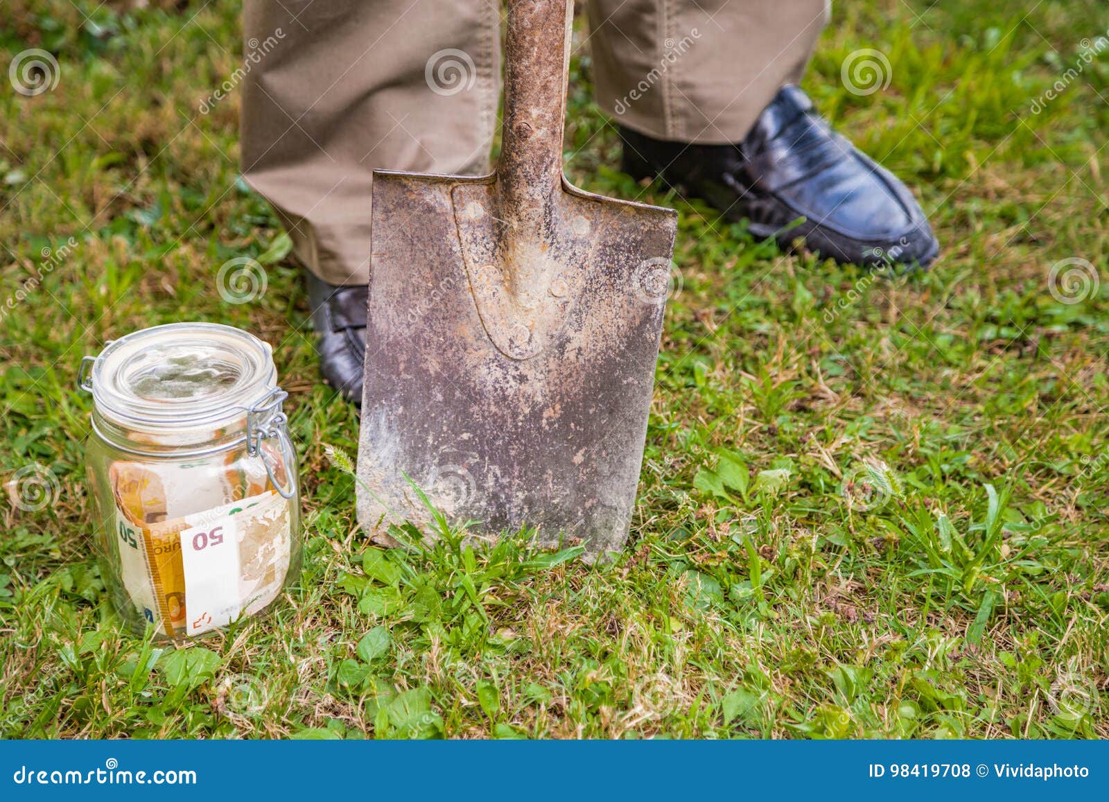 Burying a jar of money stock photo. Image of retirement - 98419708