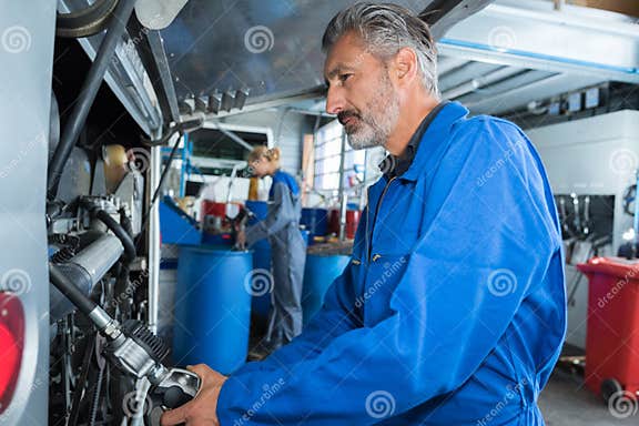 Bus mechanic at work stock photo. Image of base, water - 268033884