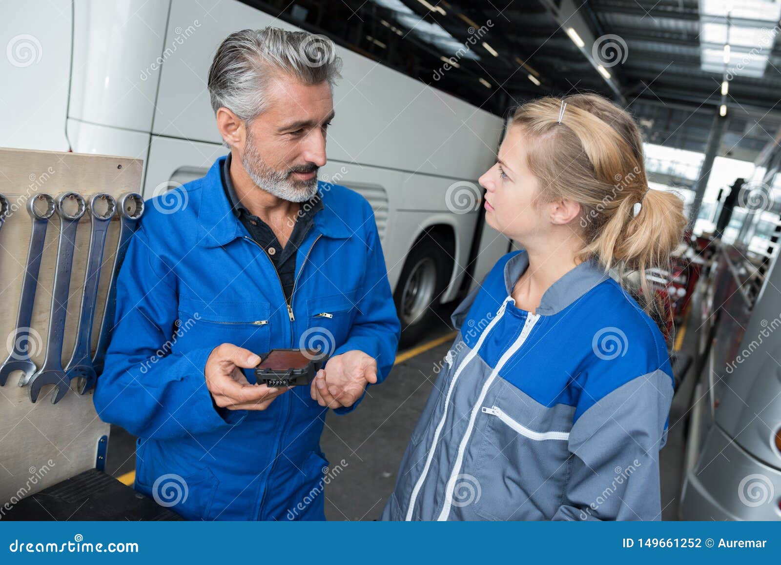 Bus Mechanics in Conversation Stock Photo - Image of conversation ...